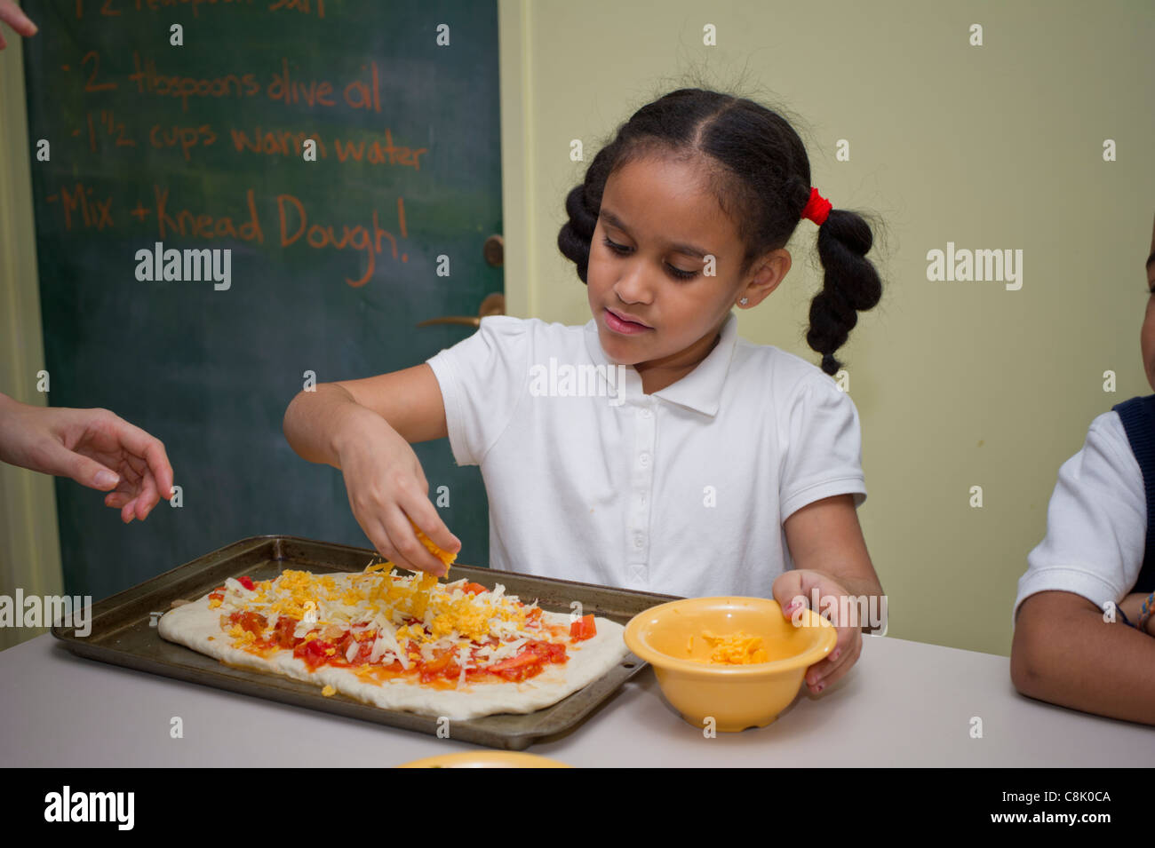 Second and third graders participate in a Plant Part Pizza cooking ...
