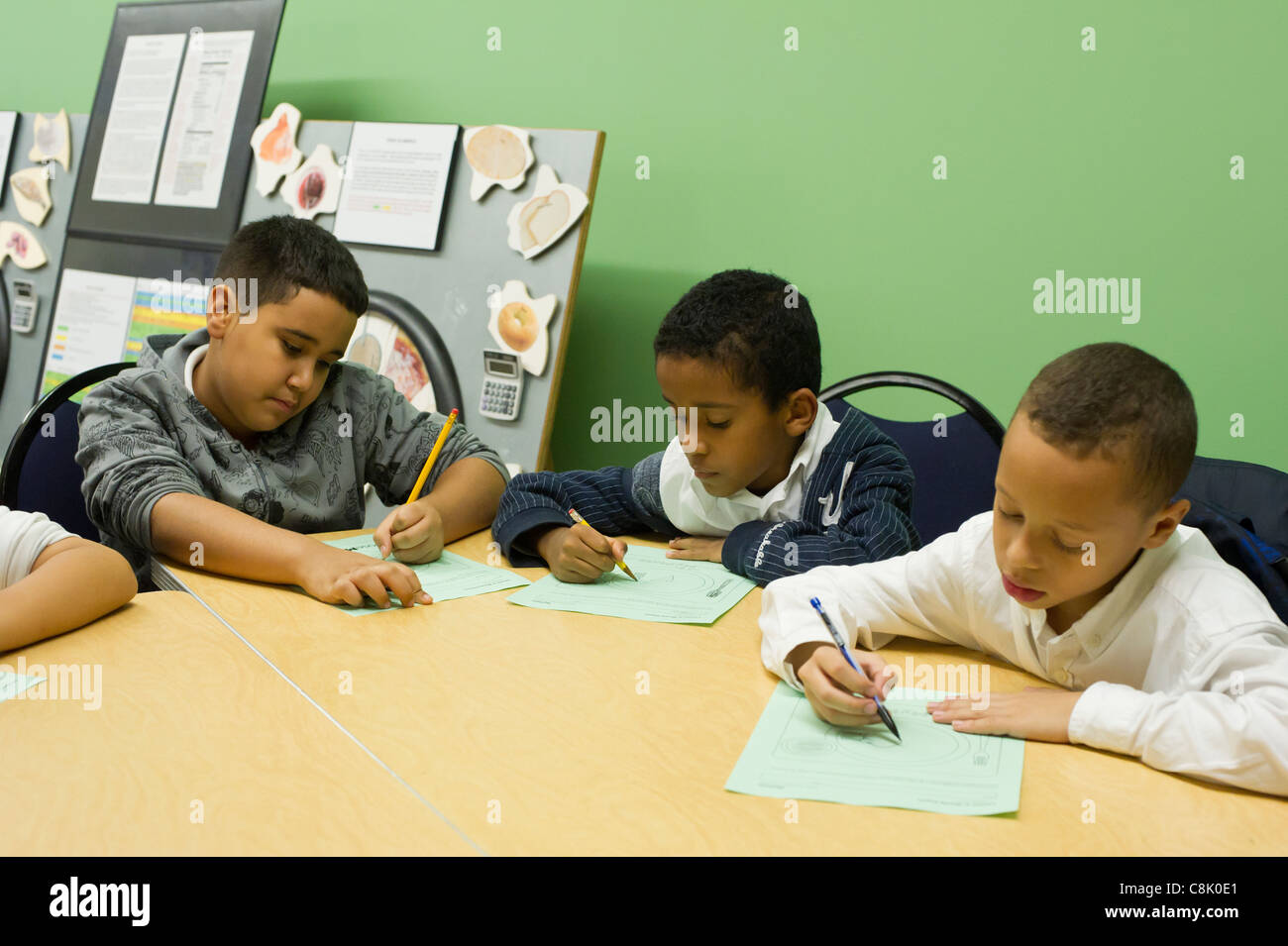 Second and third graders do an assignment during an after school ...