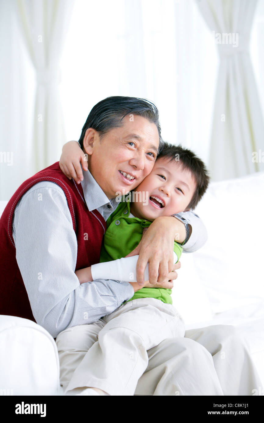 Chinese grandfather embracing grandson Stock Photo - Alamy
