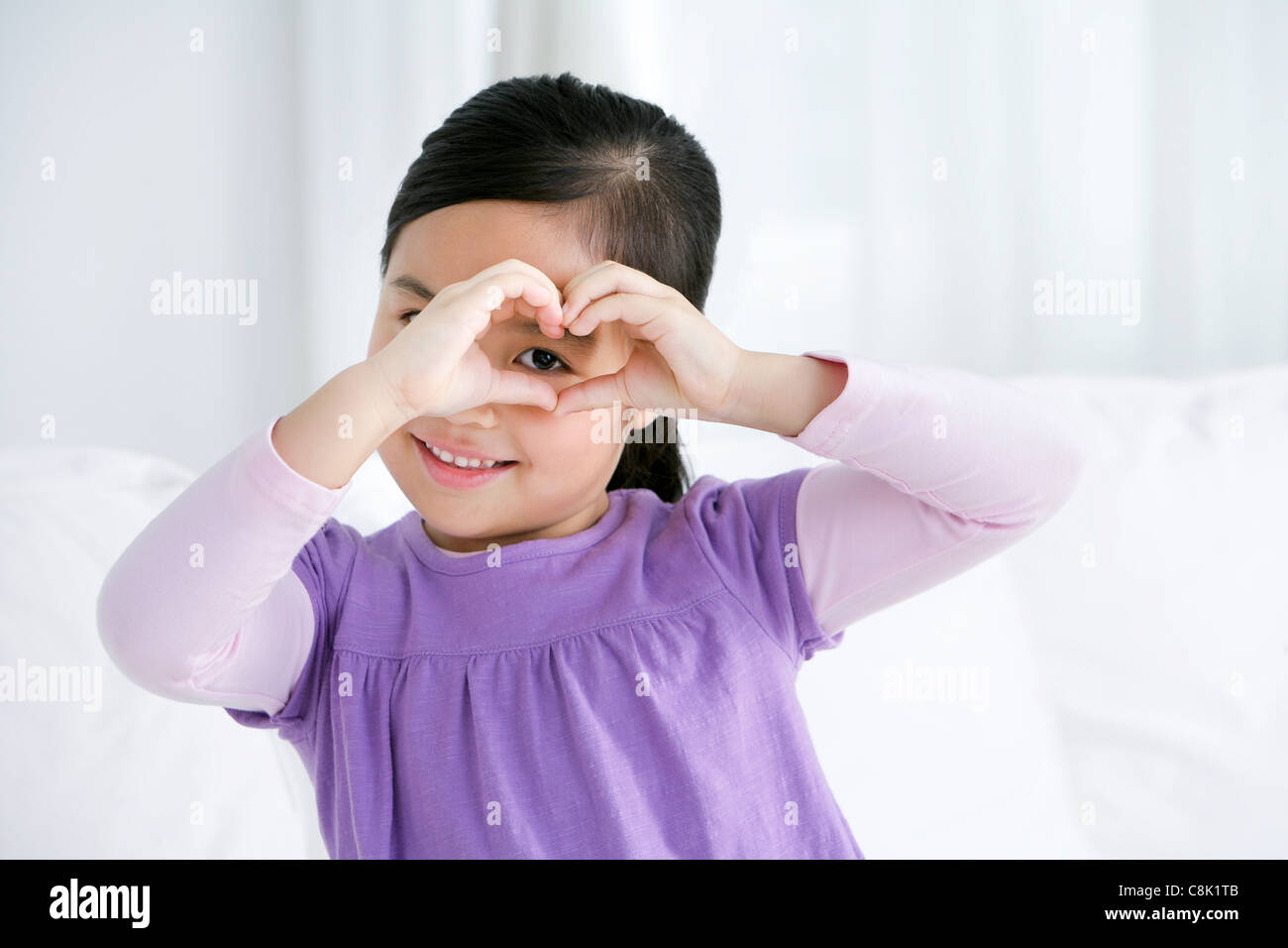 Chinese girl hands in heart shape Stock Photo - Alamy