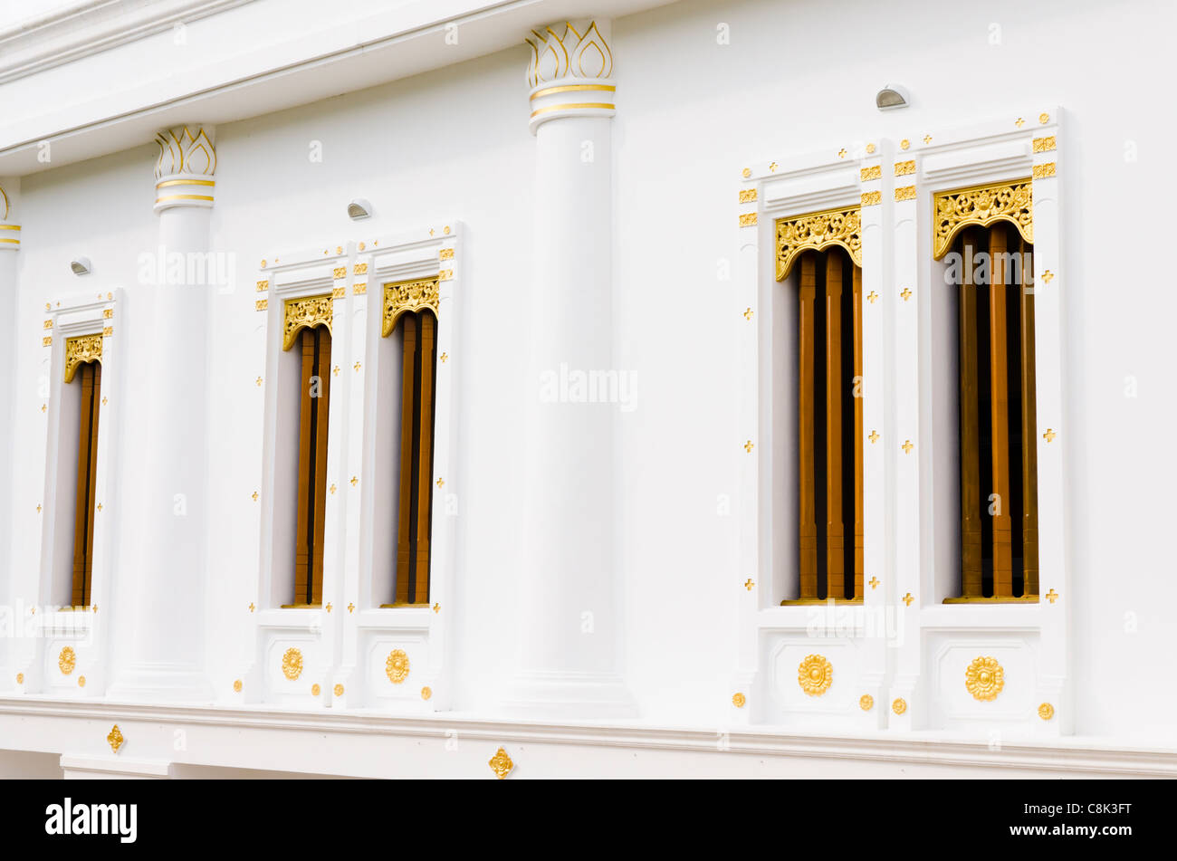 Closeup of a building's ornate gold decorated windows with vertical ...