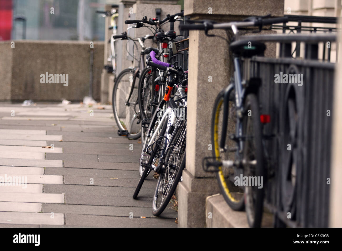 bicycles chained to railings Stock Photo - Alamy