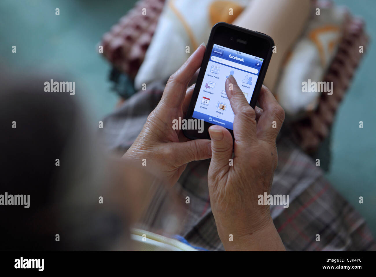 Getting to grips with smartphone 3G technology, an elderly old woman ...