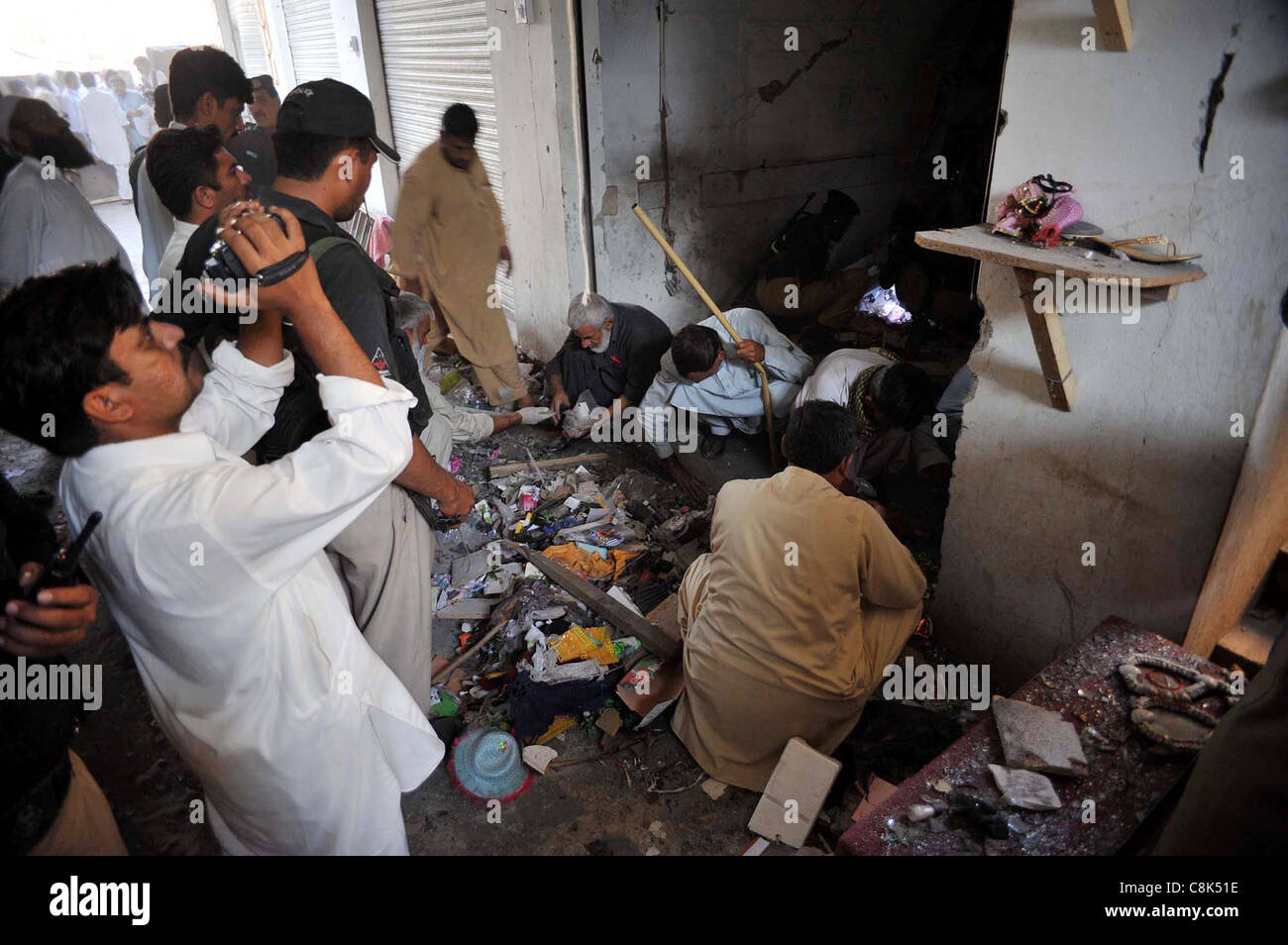 People gather at the site of explosion after explosion in Peshawar on ...