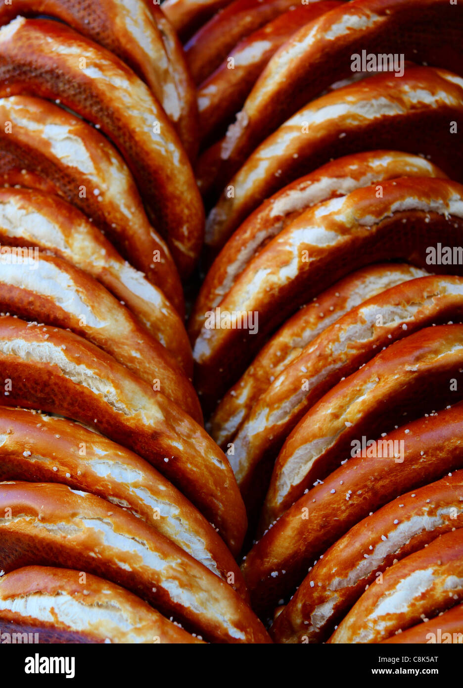 Several fresh pretzels with salt one above the other Stock Photo - Alamy