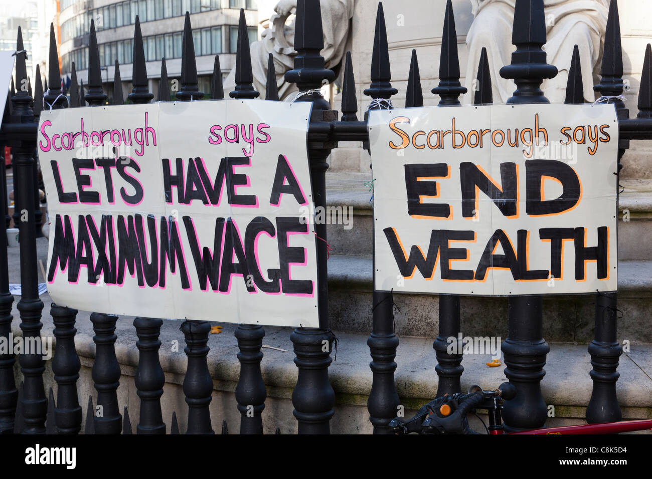 Anti-capitalist protest banners affixed to railings around St Paul's ...