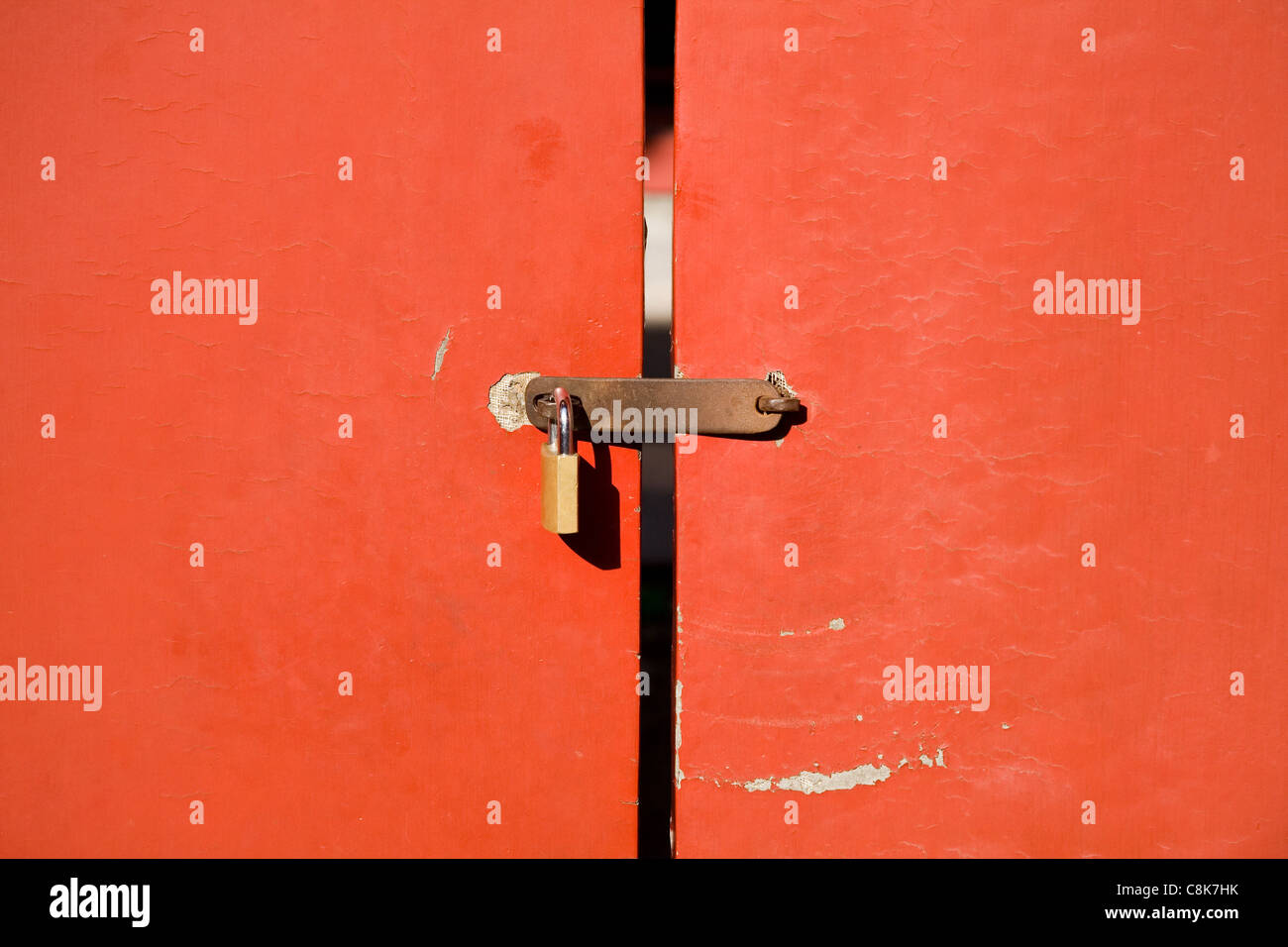 old red door with a lock Stock Photo - Alamy