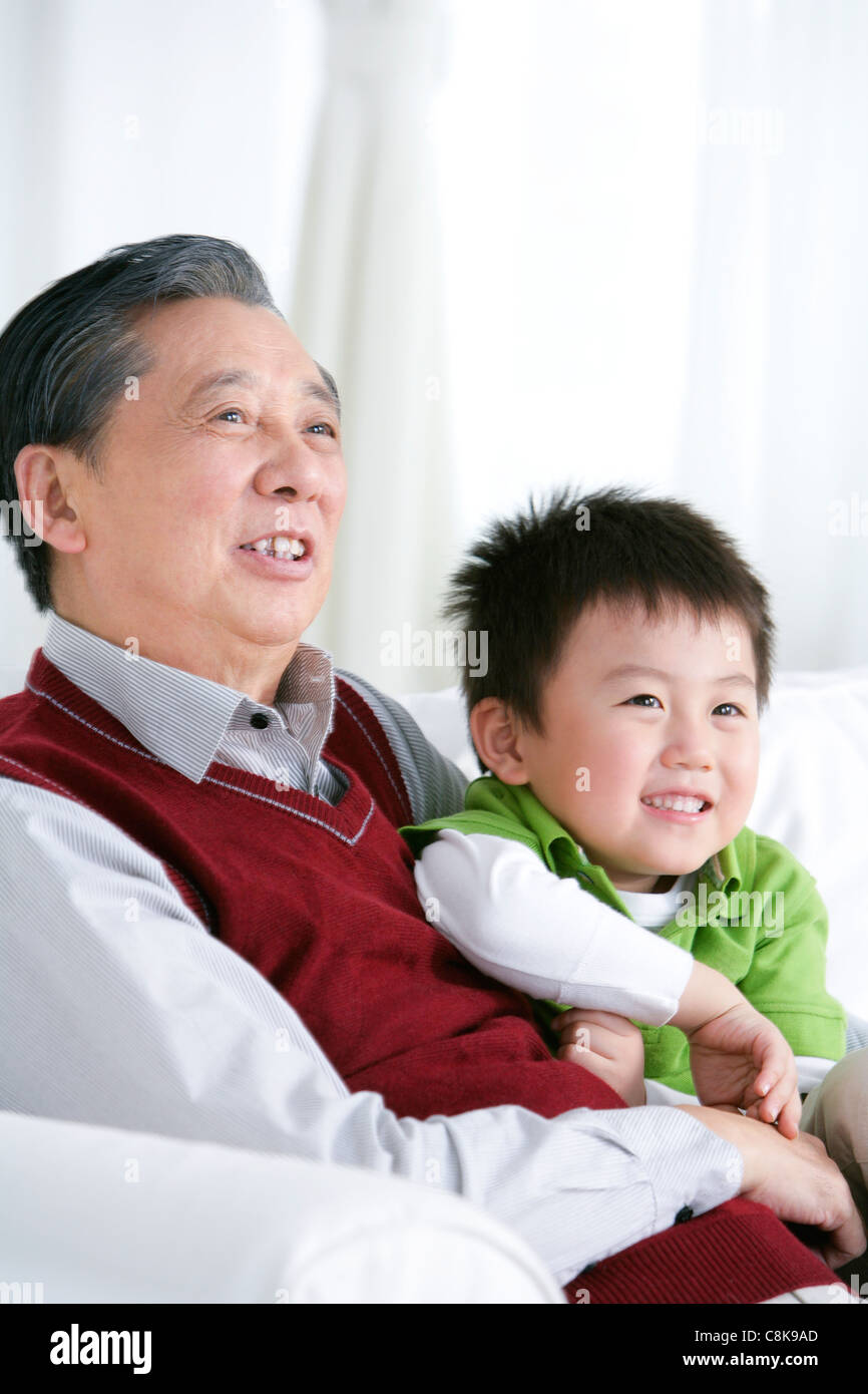 Chinese grandfather embracing grandson Stock Photo - Alamy