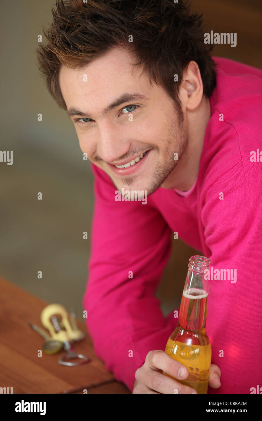 Smiling boy drinking beer Stock Photo - Alamy