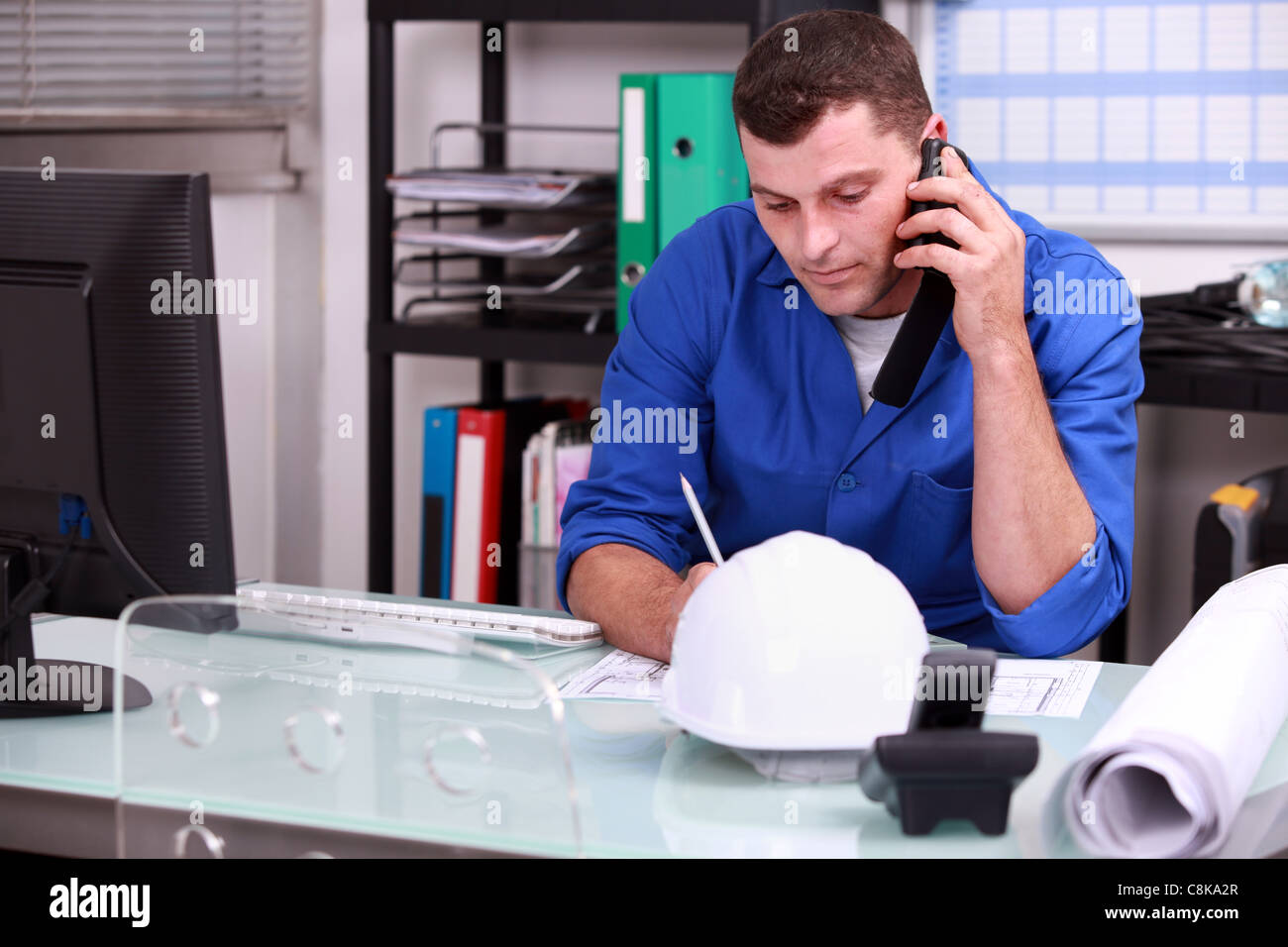 Construction foreman speaking on the phone Stock Photo - Alamy