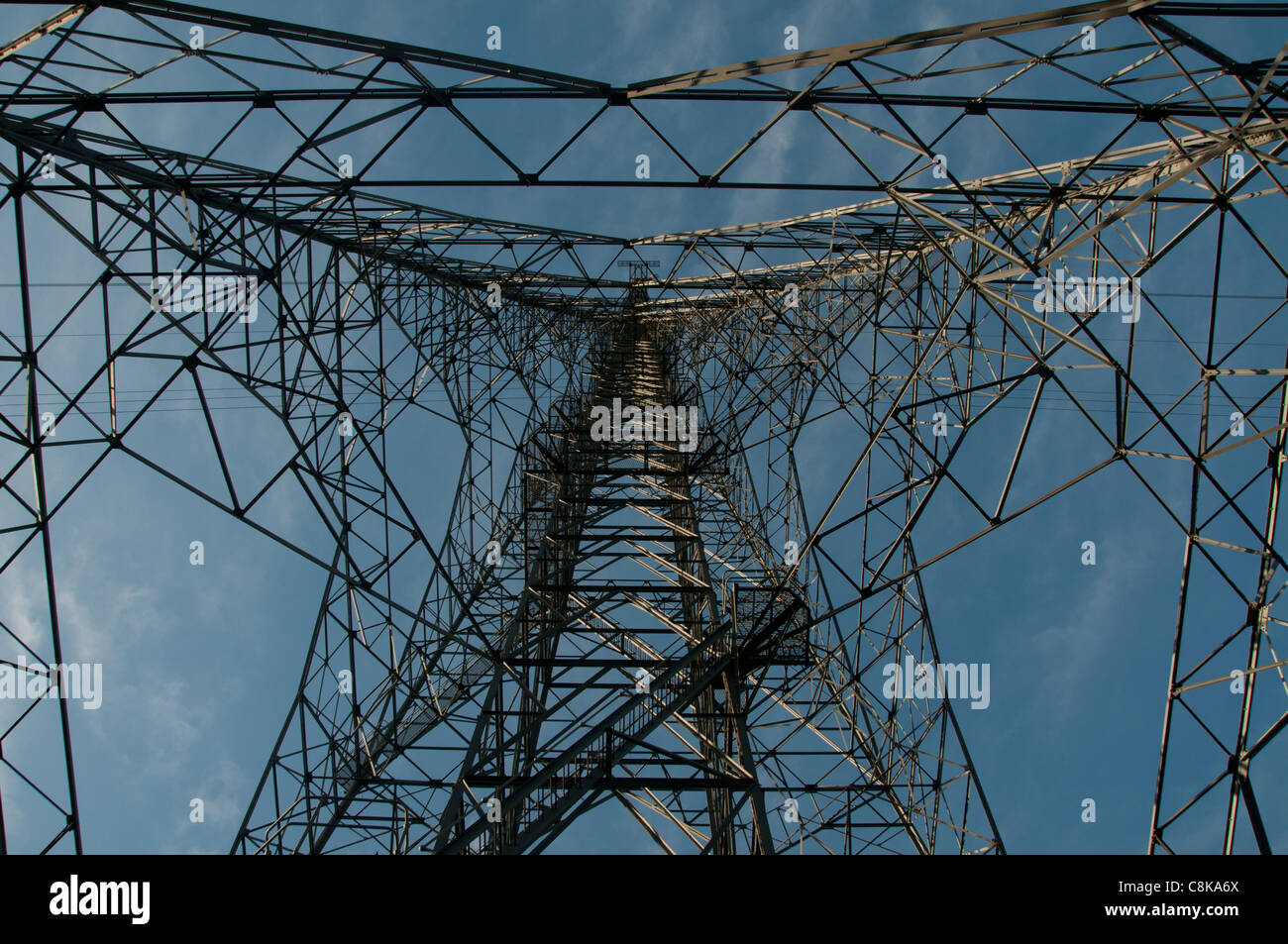 standing inside and looking up at a large electrical pylon Stock Photo ...