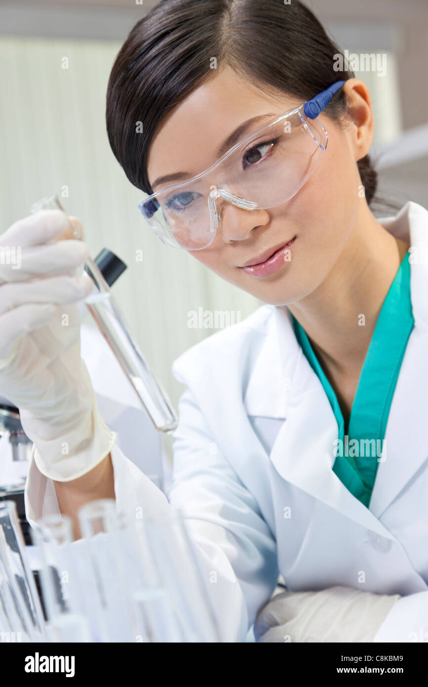 A Chinese Asian female medical or scientific researcher or doctor using ...