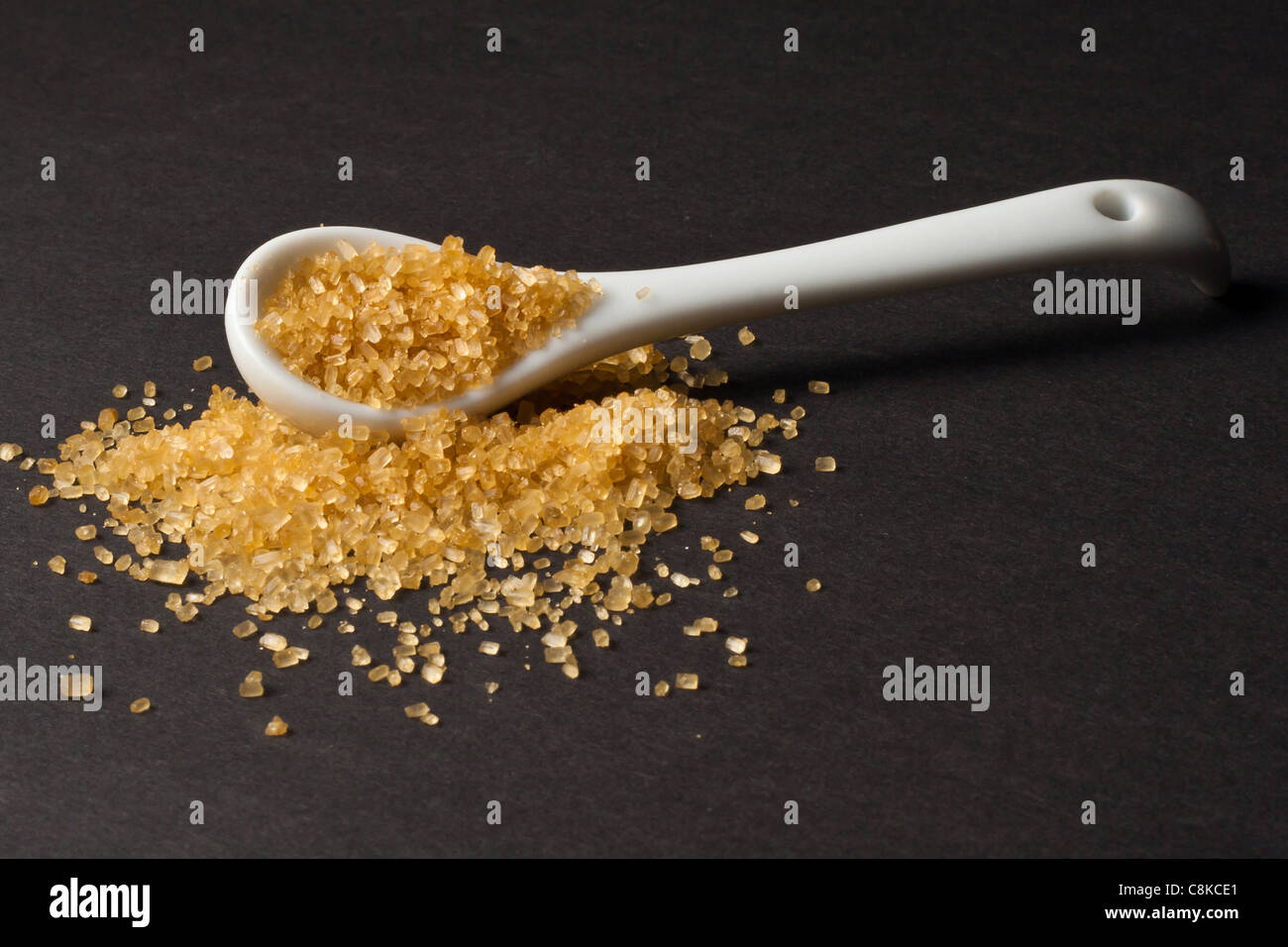 A spoon of raw sugar Stock Photo - Alamy