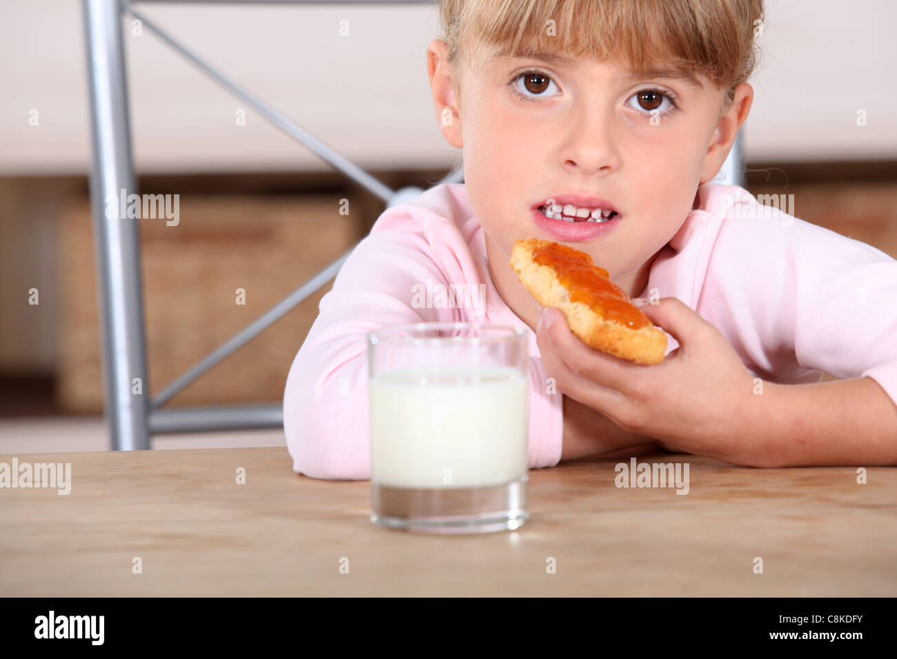 Girl having a snack Stock Photo - Alamy