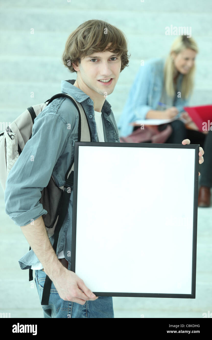 Student holding white board Stock Photo - Alamy