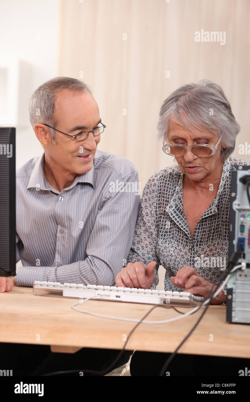 Elderly couple learning computer skills Stock Photo - Alamy