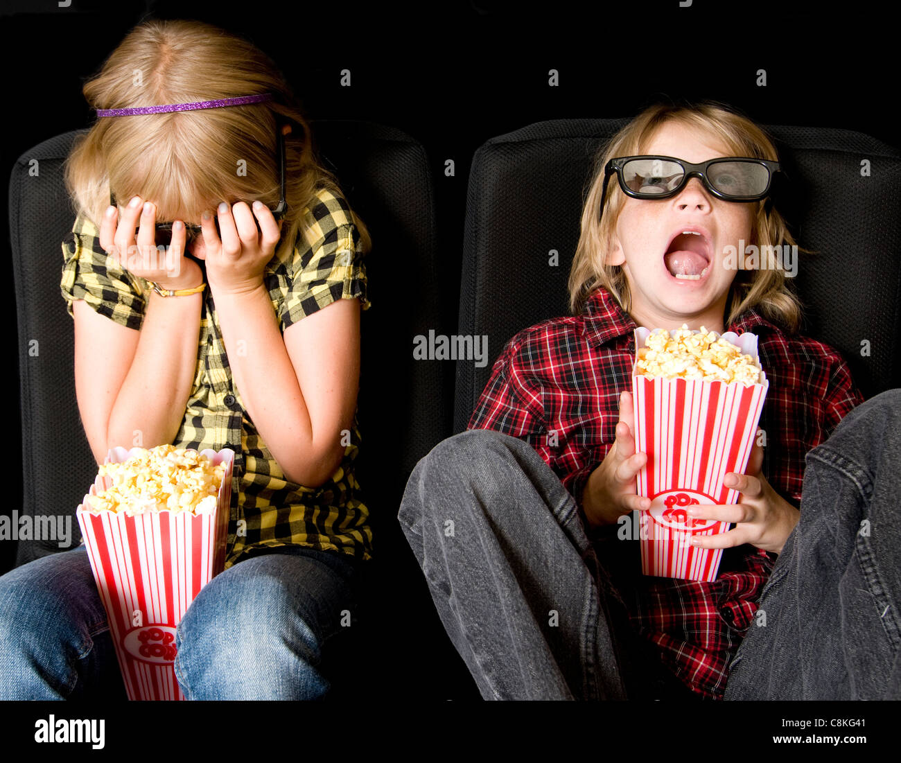 Two Kids Watching a Scary Movie in 3D Stock Photo - Alamy