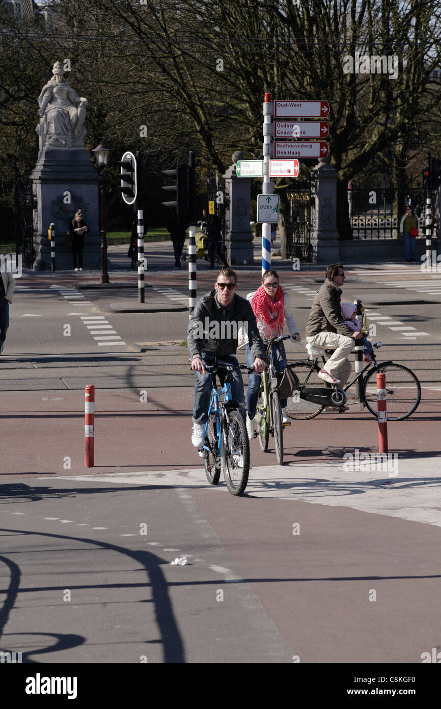 cyclists crossing road junction Vondelpark Amsterdam Holland ...