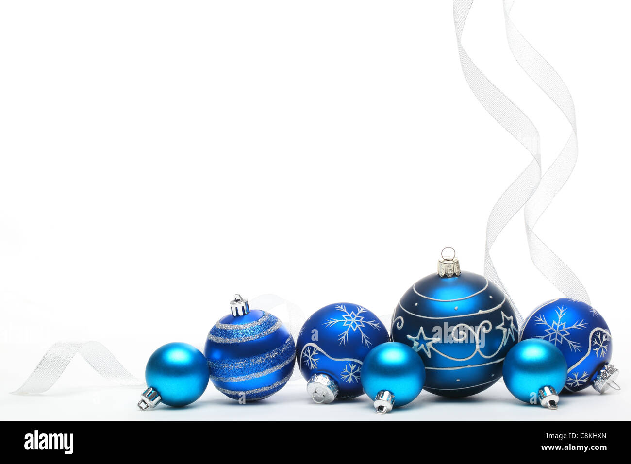 Blue Christmas balls with ribbons isolated on white Stock Photo - Alamy