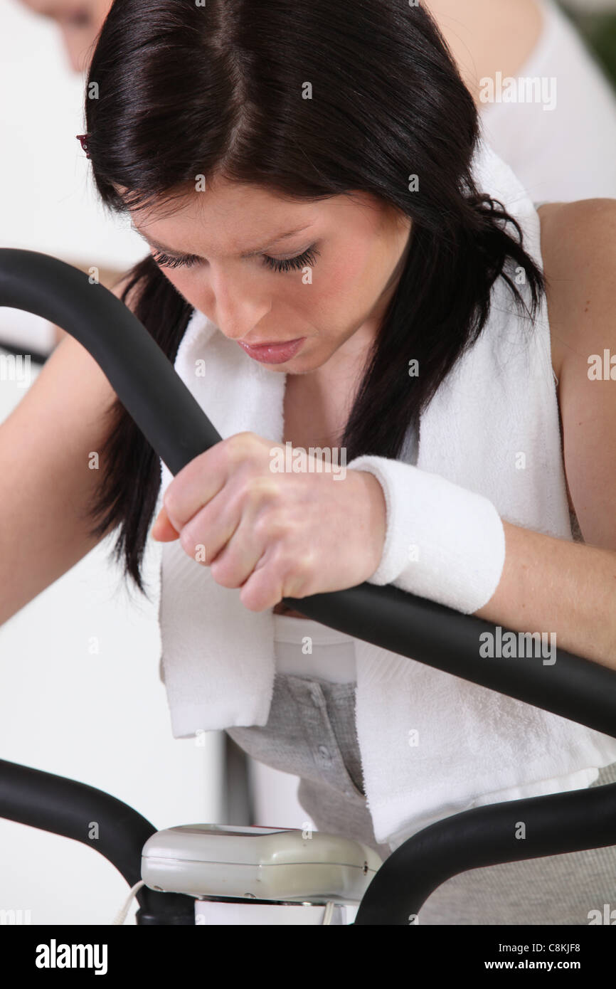 Woman using an exercise machine Stock Photo - Alamy