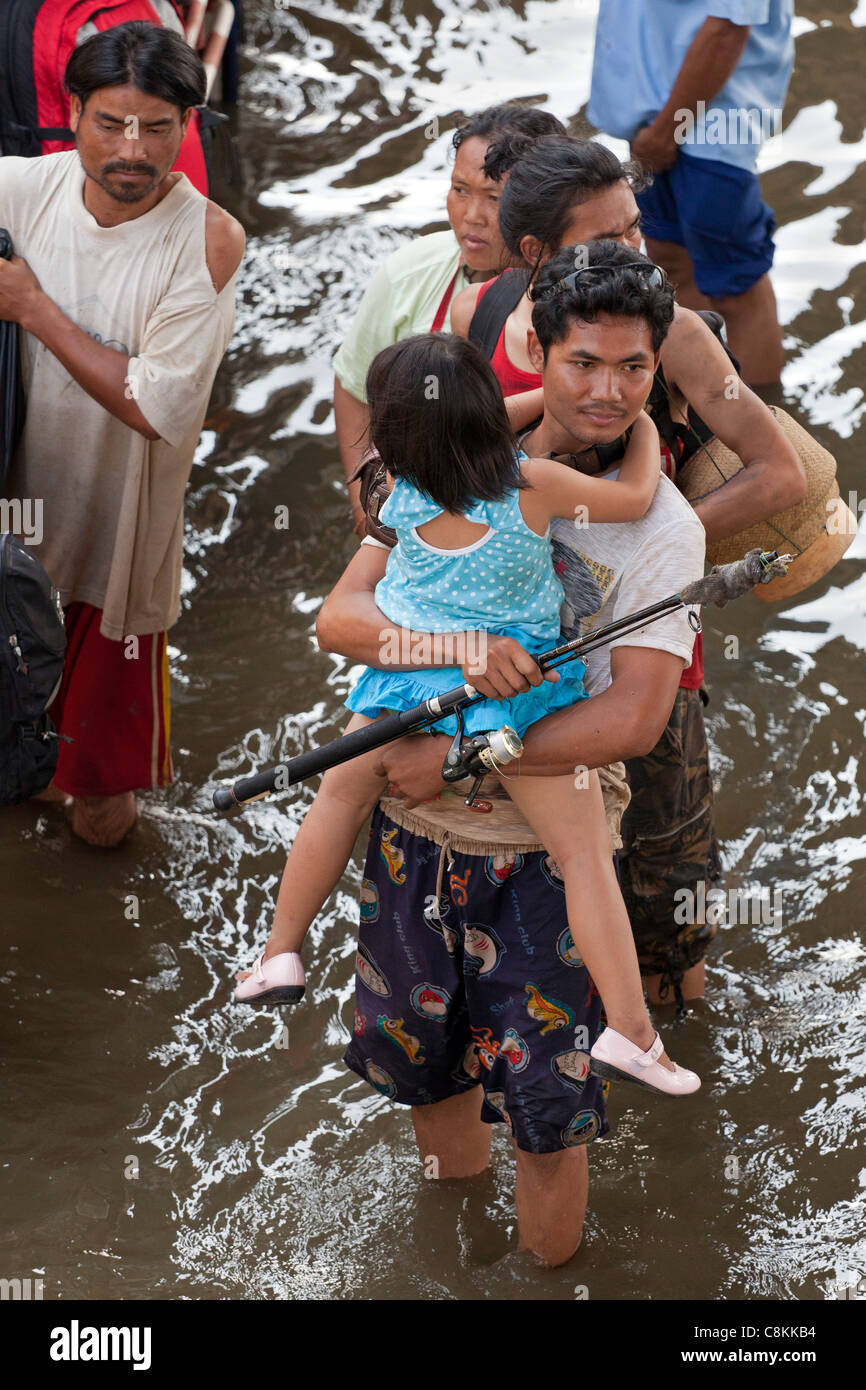 People wading through flood water in Bangkok city centre, Thailand ...