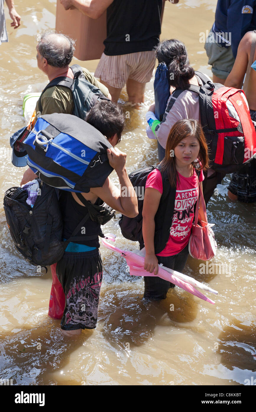 People wading through flood water in Bangkok city centre, Thailand ...