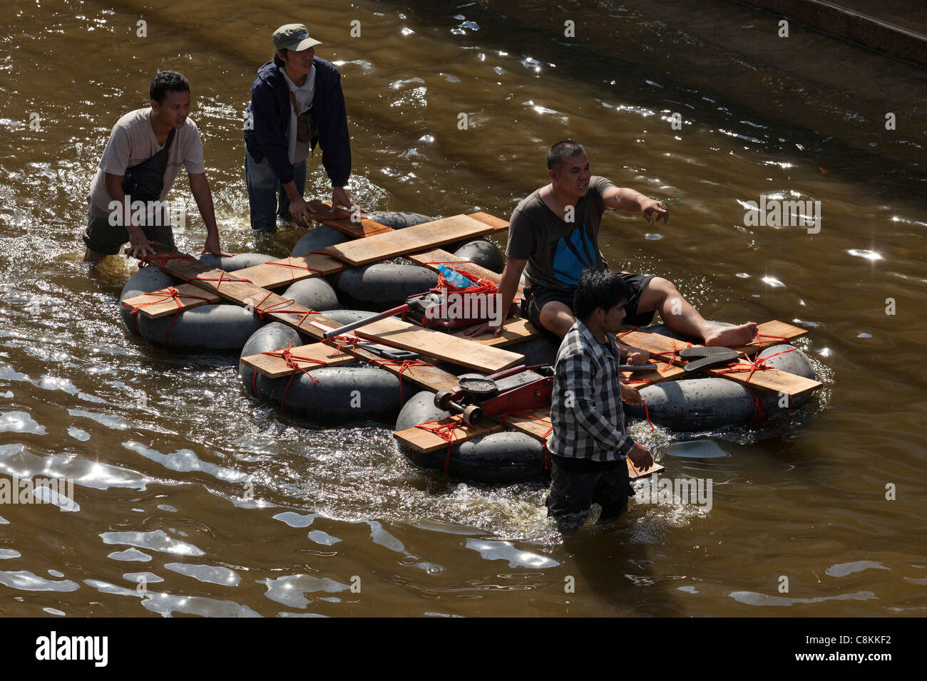 Floating a raft through flooded street, Bangkok, Thailand Stock Photo ...