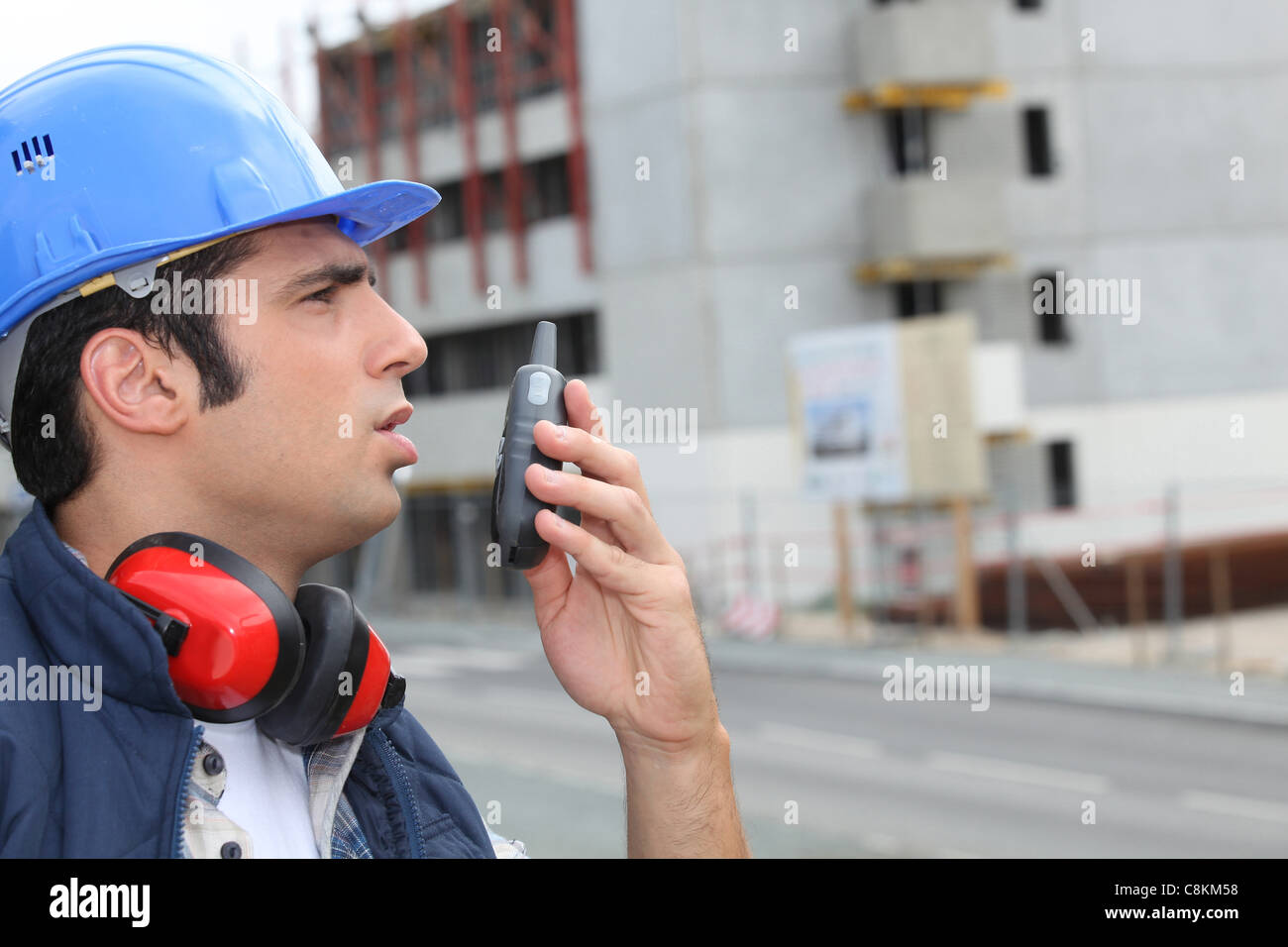 Man speaking into a walkie-talkie Stock Photo - Alamy
