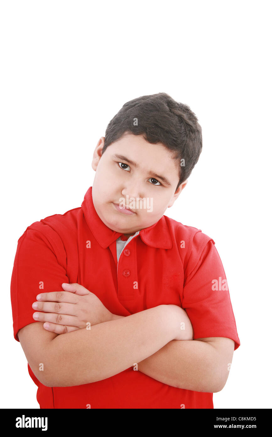 serious little boy with hands folded standing isolated on white ...