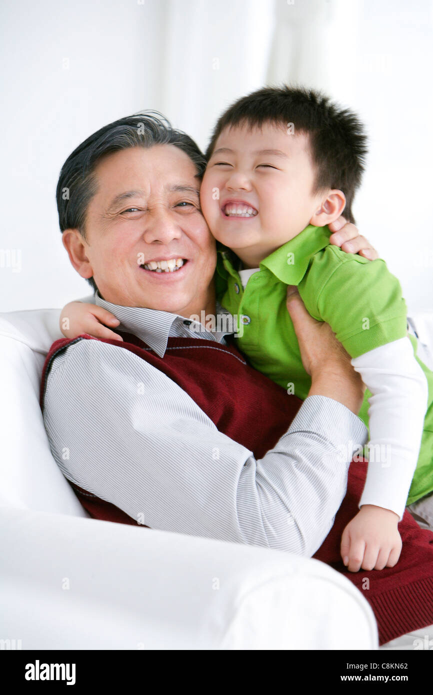 Chinese grandfather embracing grandson Stock Photo - Alamy