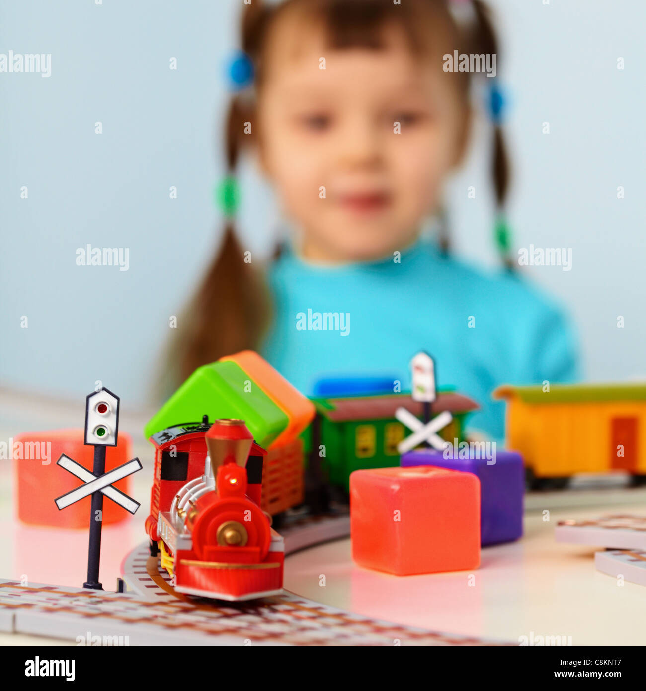 Little girl plays with a toy railroad Stock Photo - Alamy
