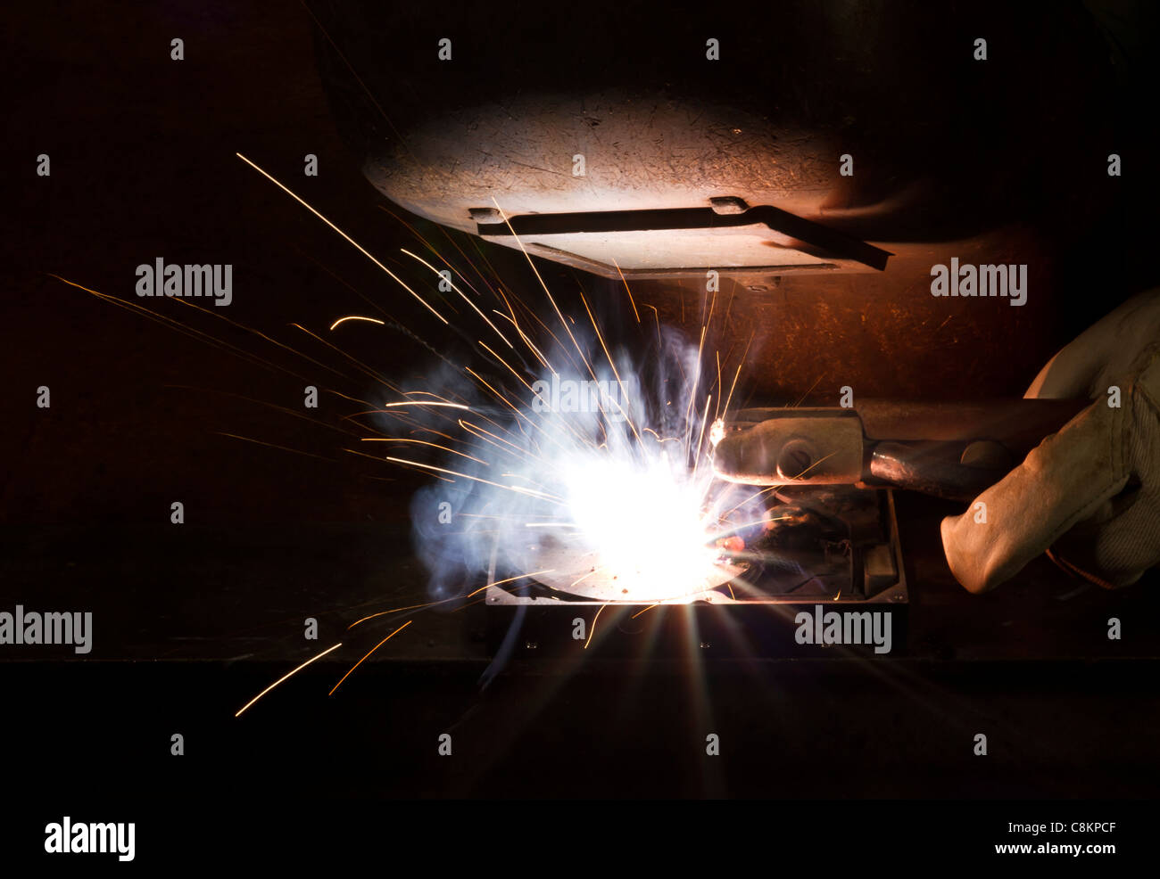 welding scenery with hard disk drive, welding mask detail and flashy ...