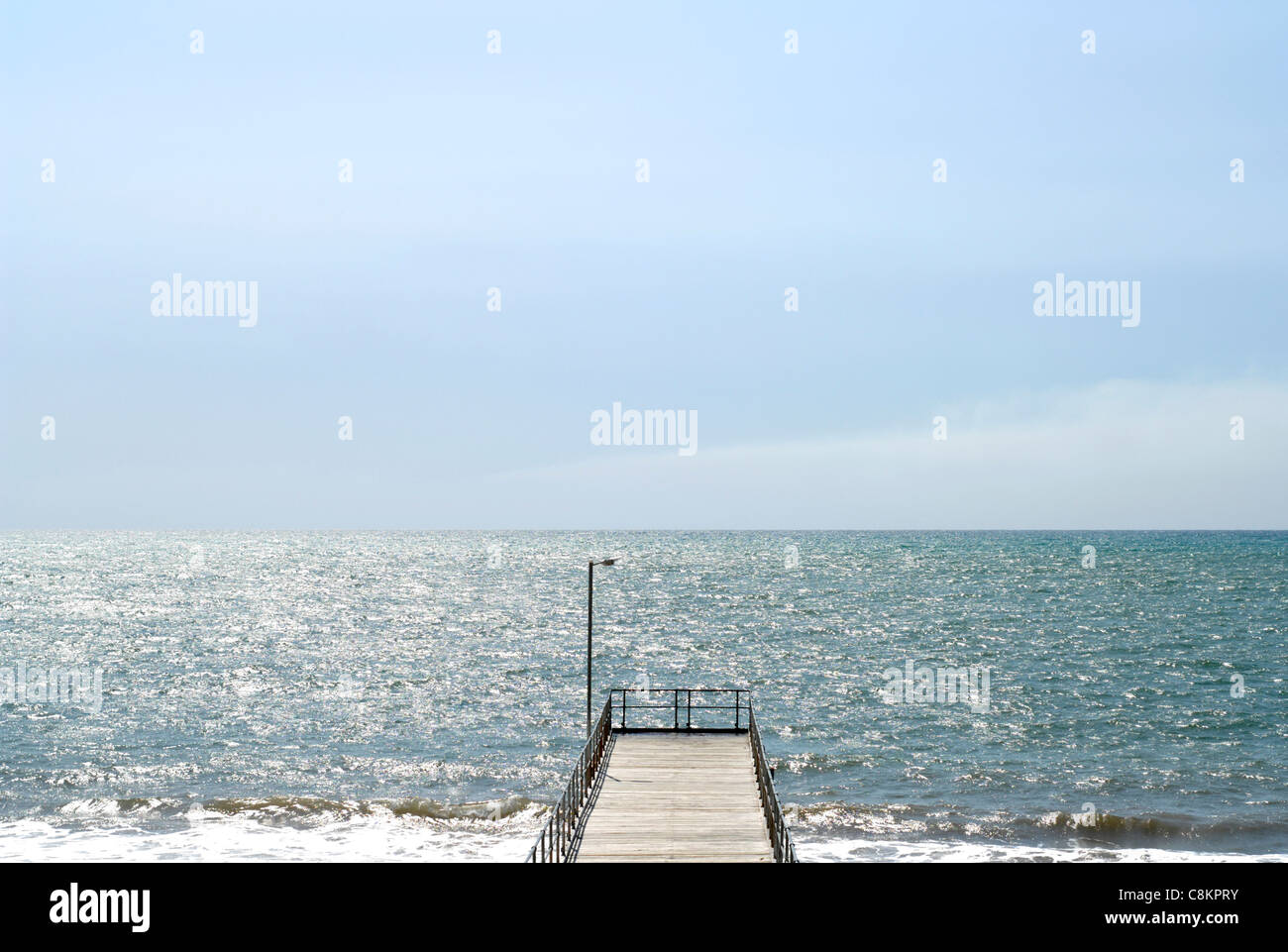 Jetty over glistening sea Stock Photo - Alamy