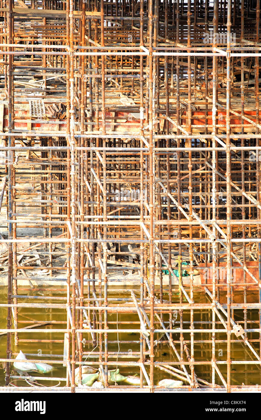 portrait of rusty scaffolding and scaffold erection of an 18th storey ...