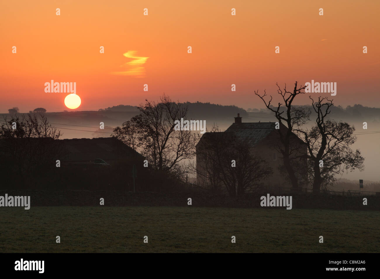Sun rising over a farmhouse in Fewston, Yorkshire, England Stock Photo ...