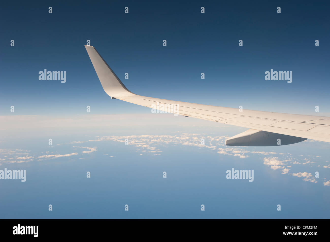 View from a large aircraft in flight with the wing against a blue sky ...