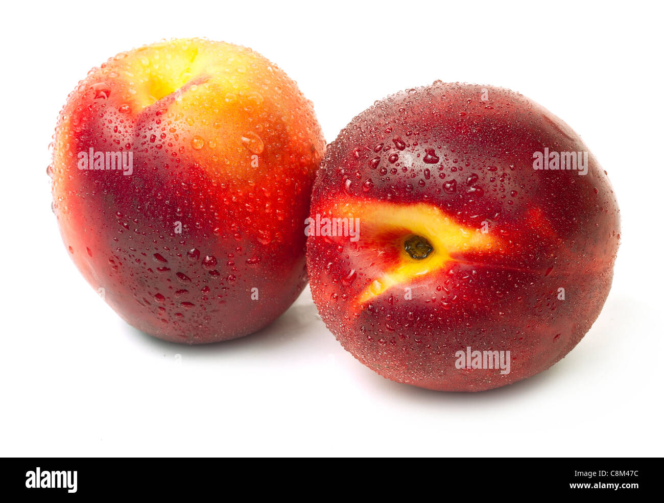 Two fresh nectarines with water drops isolated on white background ...