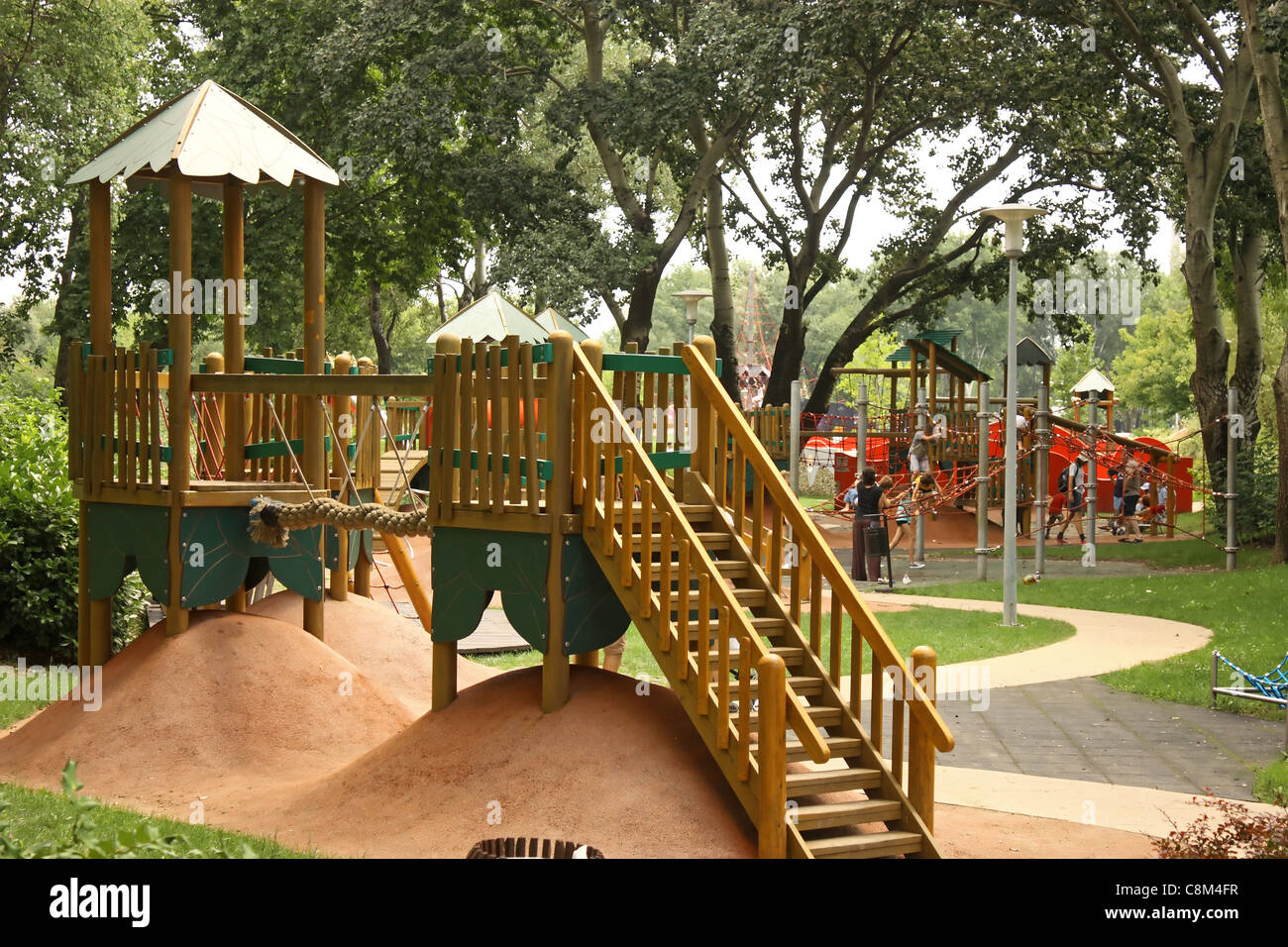 Playground for children in shade of trees Stock Photo - Alamy