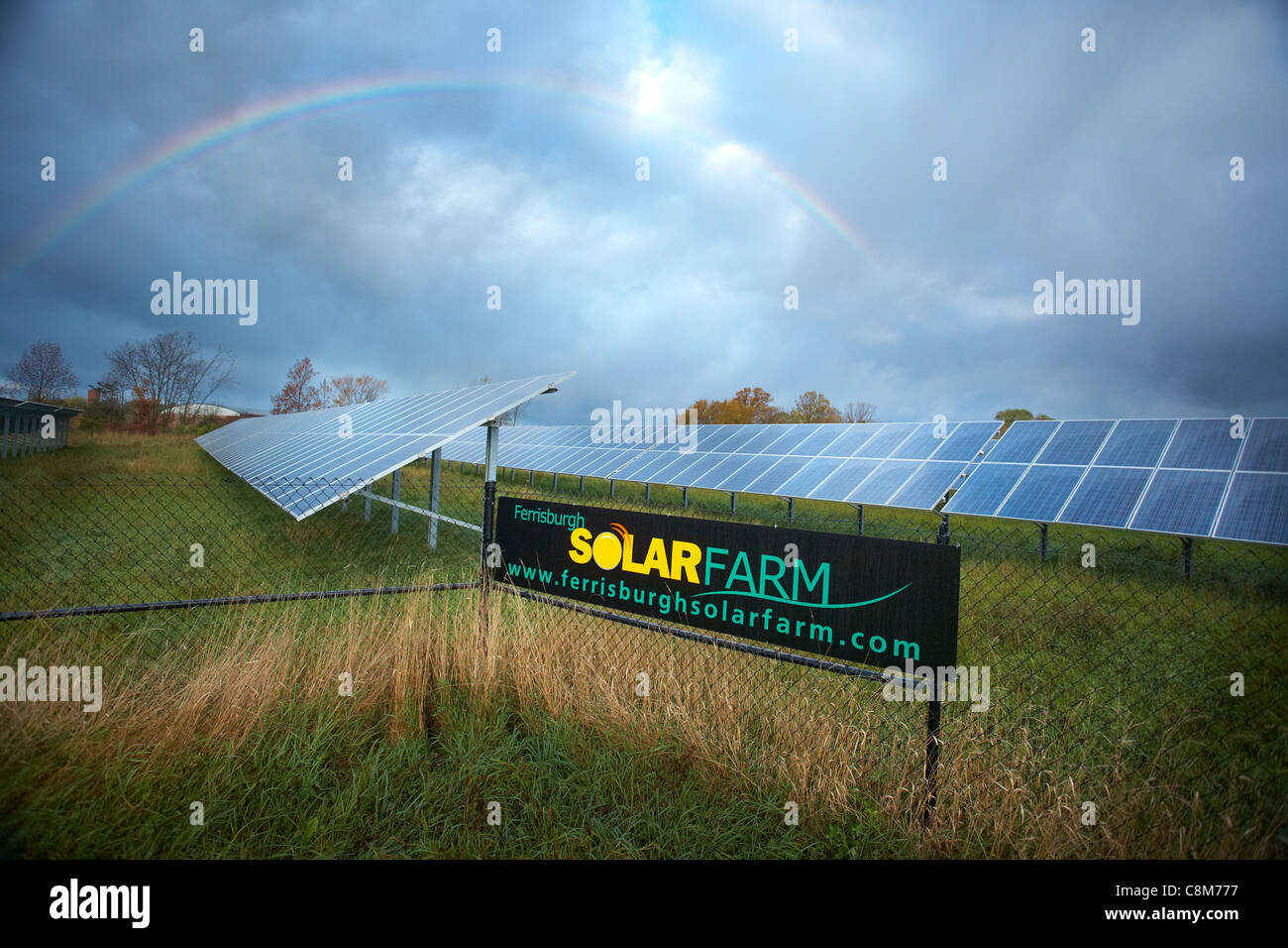 rainbow over solar electric array Stock Photo - Alamy