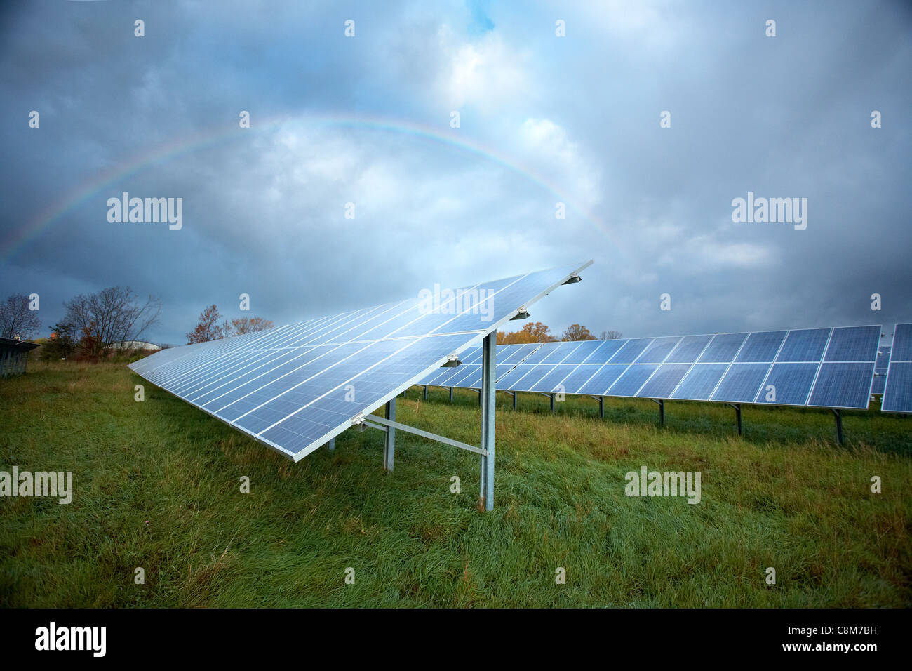 rainbow over solar electric array Stock Photo - Alamy