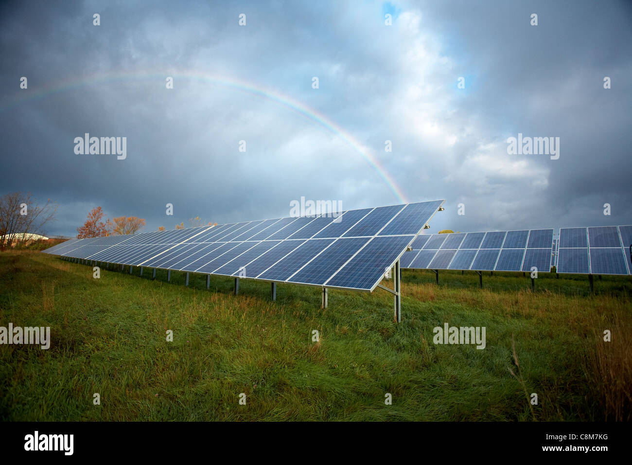rainbow over solar electric array Stock Photo - Alamy