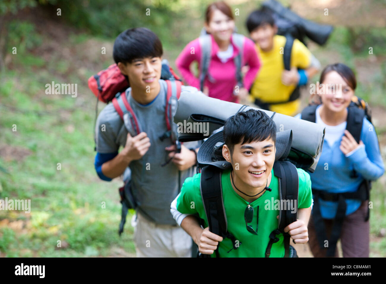 Young people go hiking in mountain Stock Photo - Alamy
