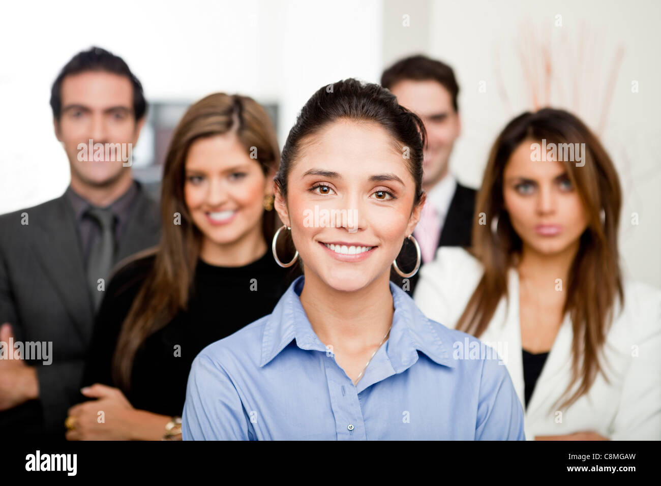 Hispanic business people standing together in office Stock Photo - Alamy