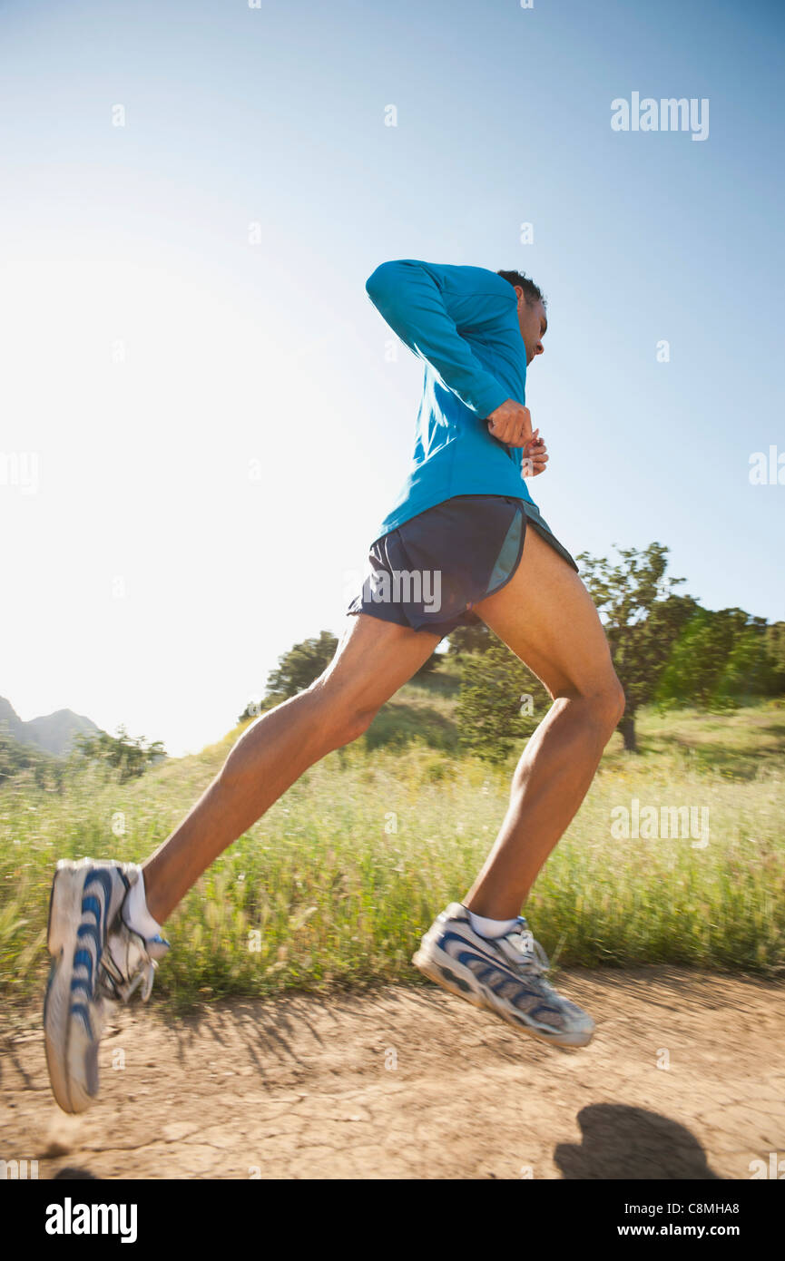 Mixed race man running on remote trail Stock Photo - Alamy