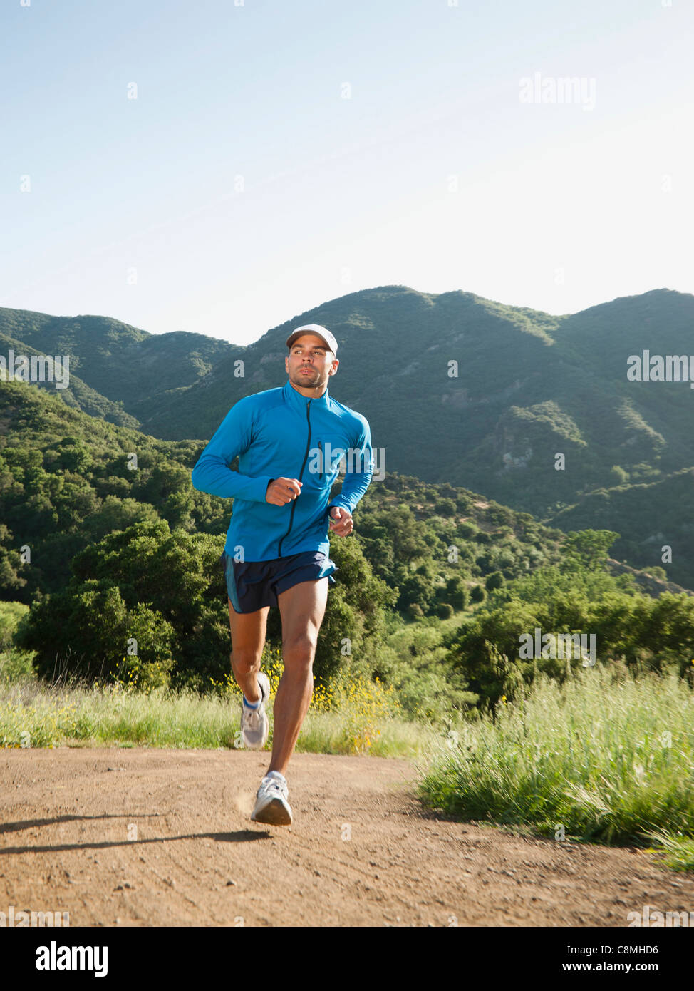 Mixed race man running on remote trail Stock Photo - Alamy