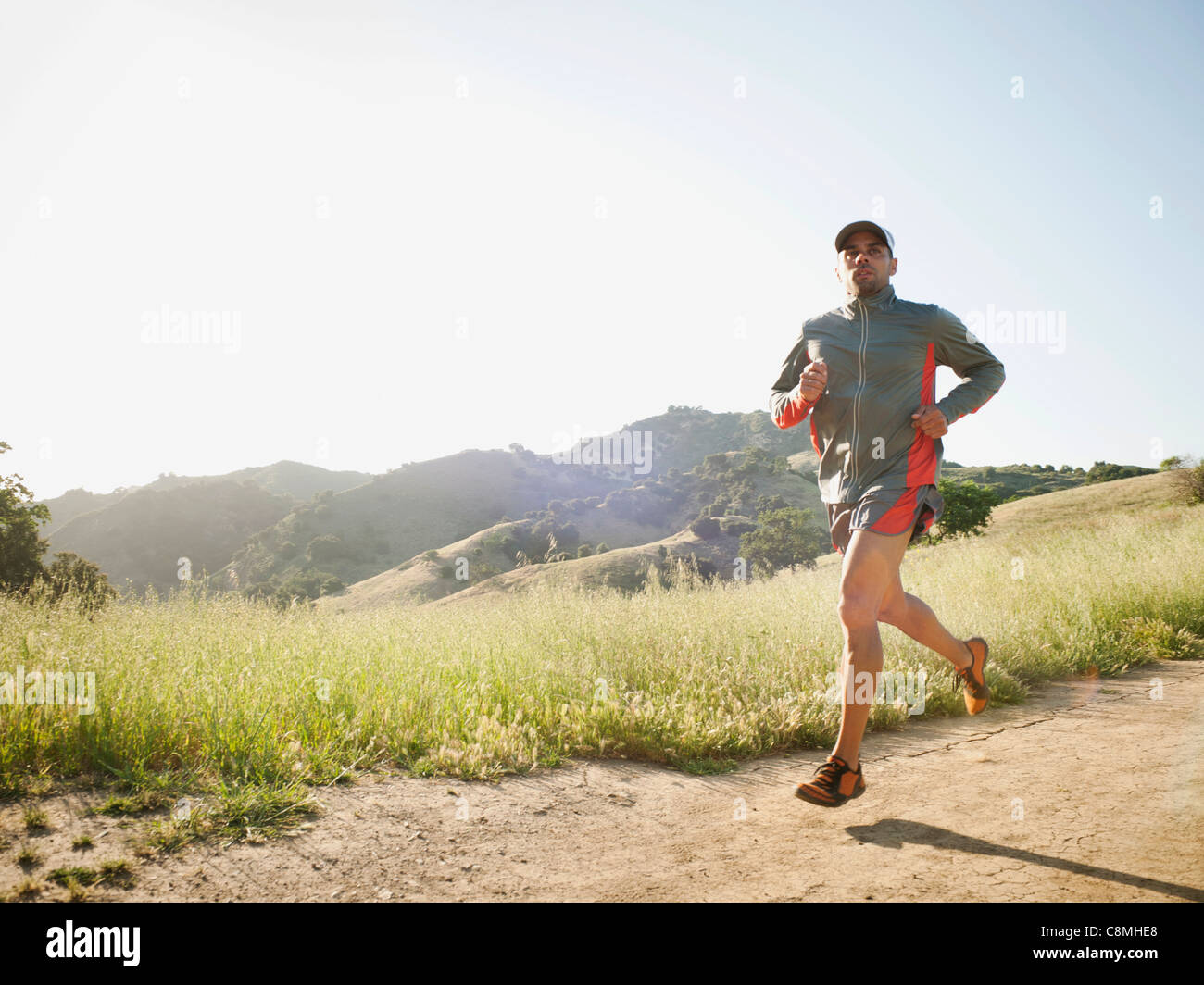 Mixed race man running on remote trail Stock Photo - Alamy