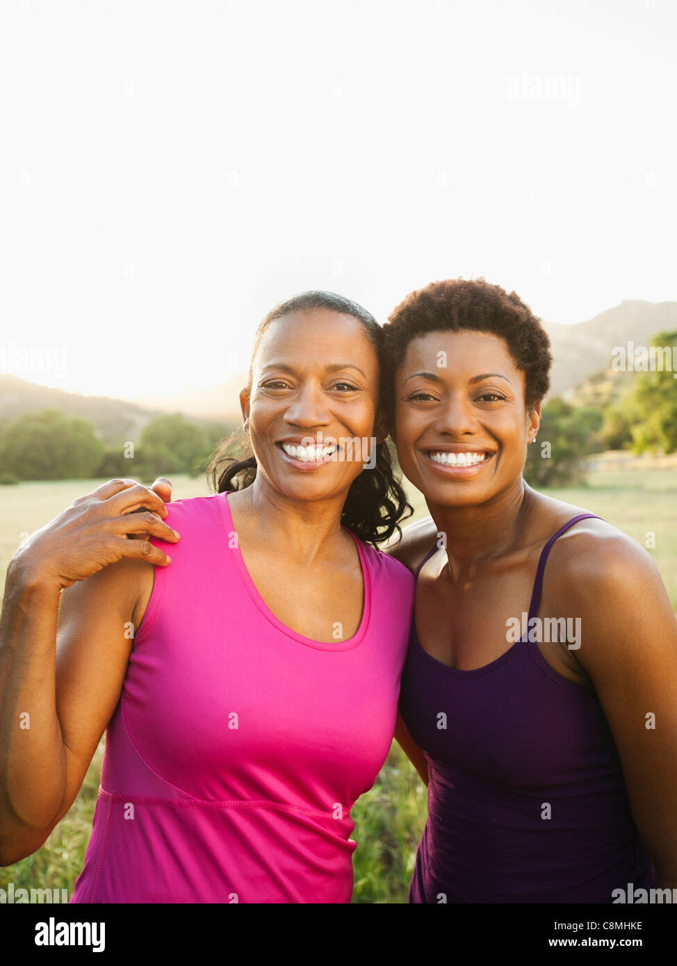 Smiling friends hugging outdoors Stock Photo - Alamy