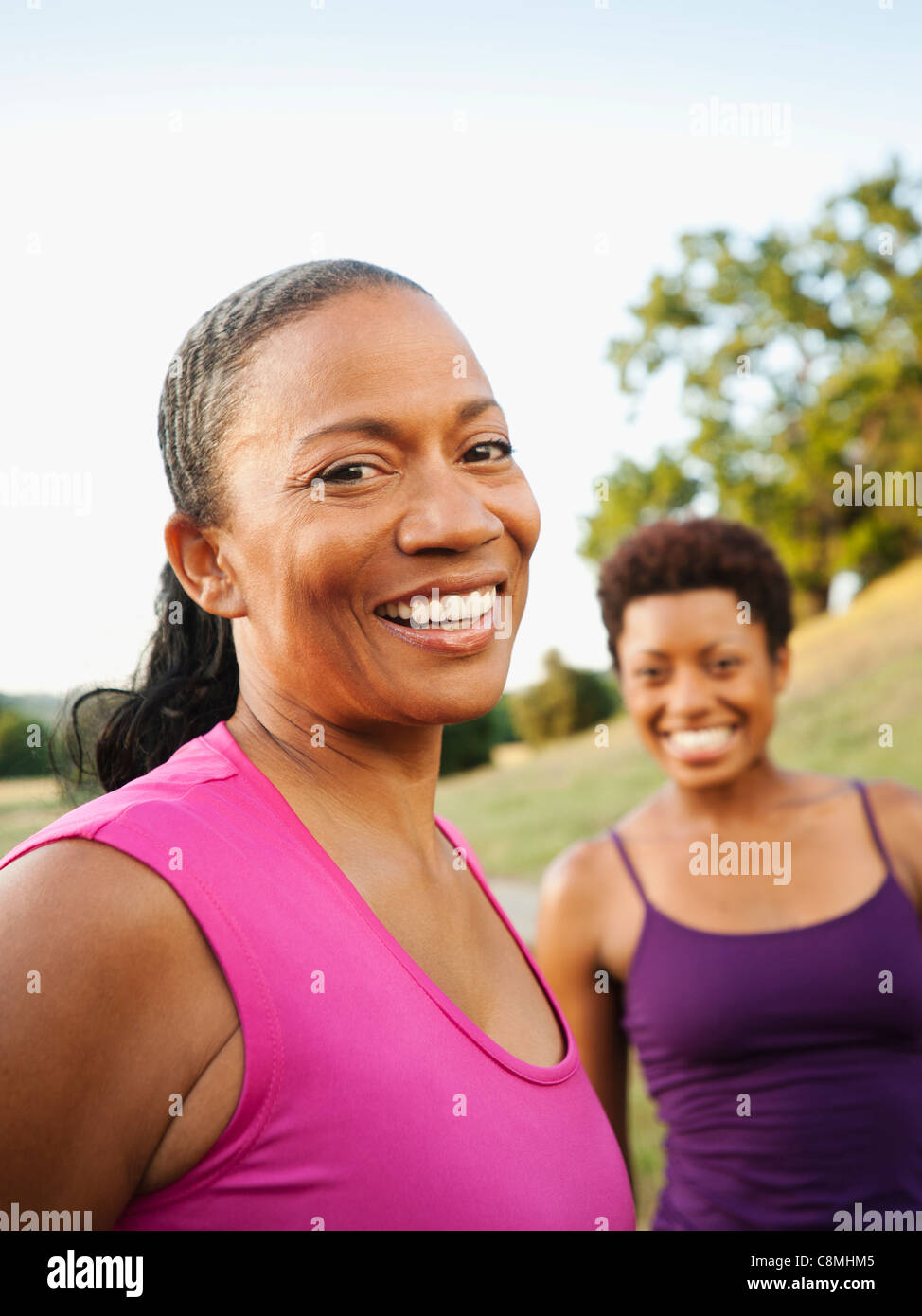 Smiling friends standing together outdoors Stock Photo - Alamy