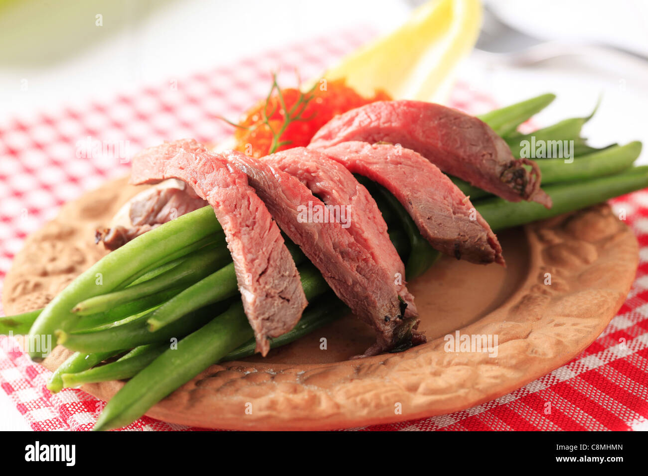 Strips of roast beef and string beans Stock Photo - Alamy