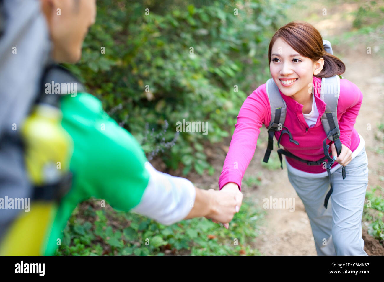 Young people go hiking in mountain Stock Photo - Alamy